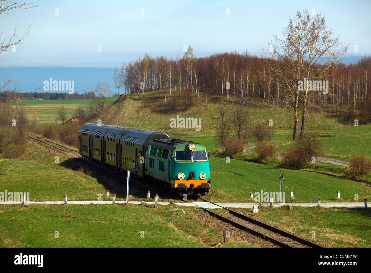 Passenger train passing through countryside Stock Photo - Alamy