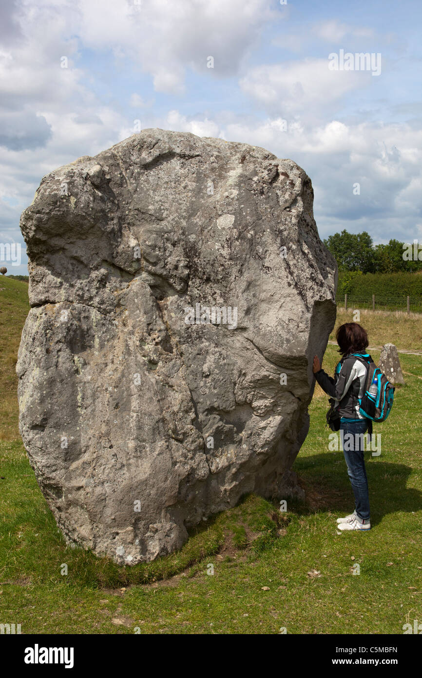 Woman touching one of the stones at Avebury Wiltshire England UK Stock ...