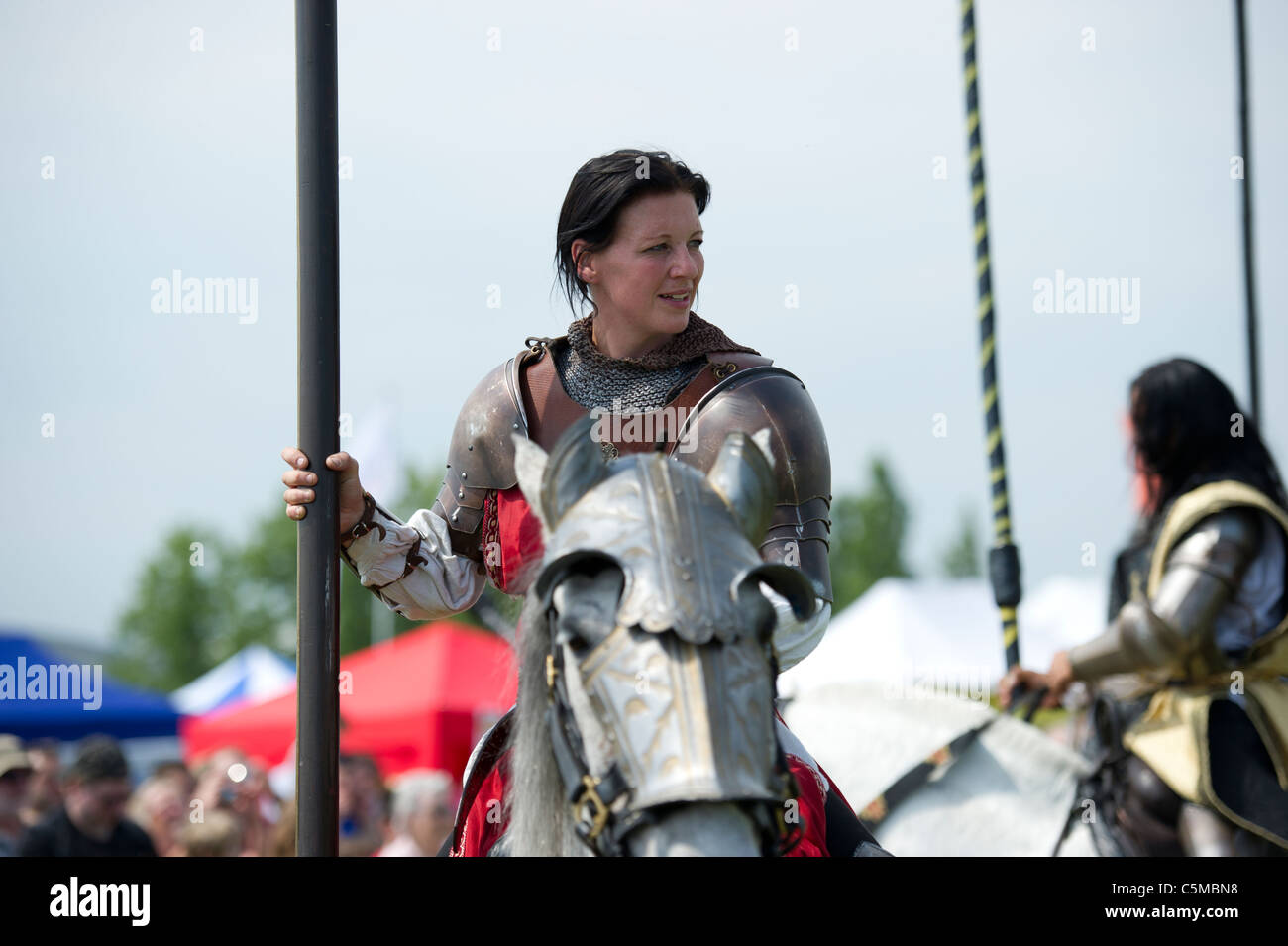 An attractive woman equestrian dressed as a knight as part of a ...