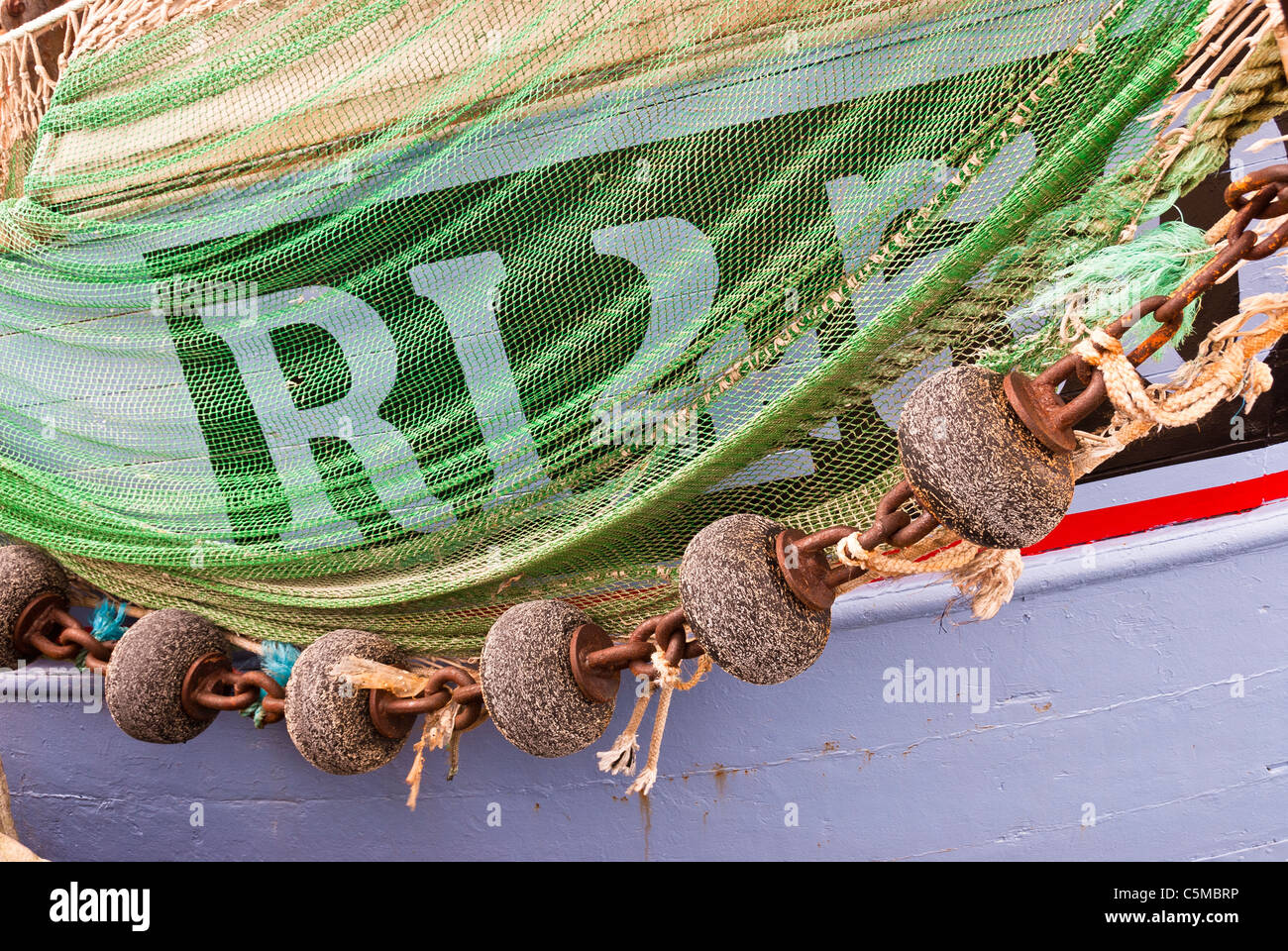 Fishing boat detail with chain and fishnet Stock Photo - Alamy