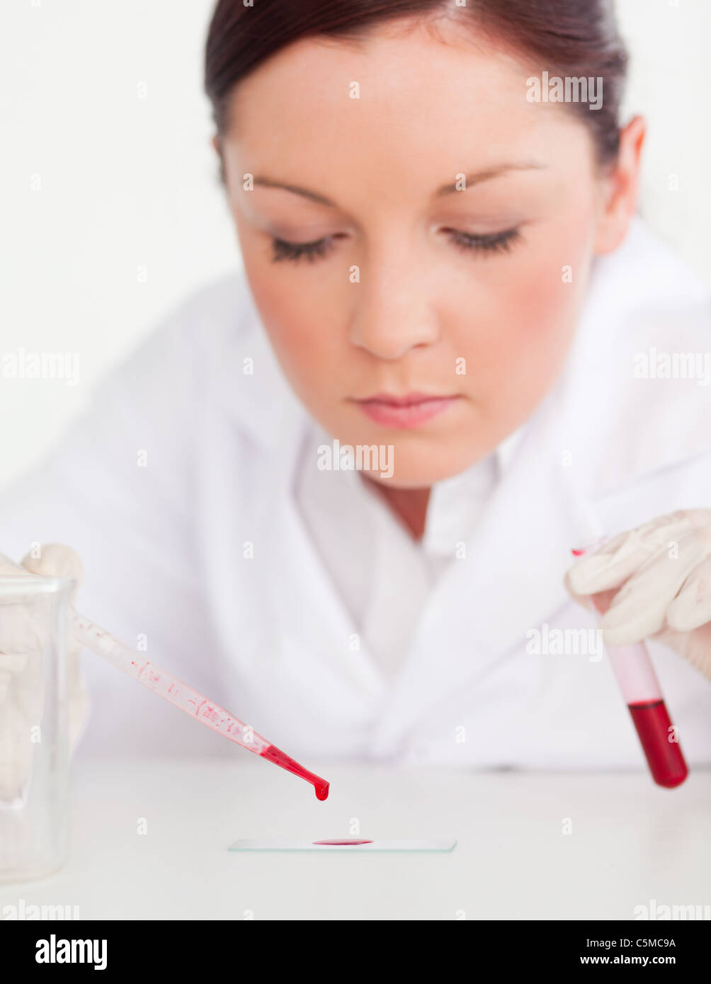 Attractive scientist holding a test tube Stock Photo - Alamy