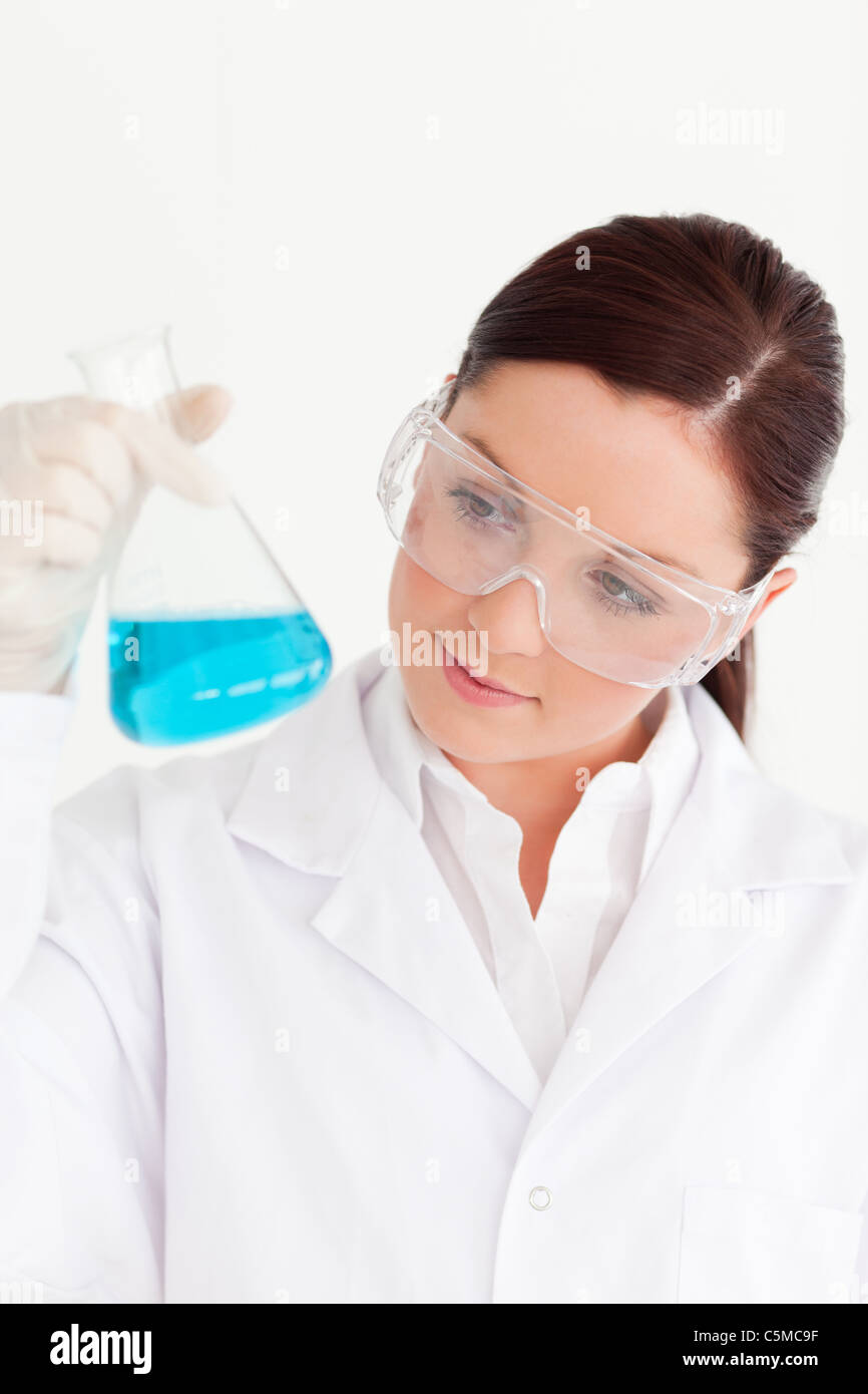 Attractive scientist holding a beaker in a laboratory Stock Photo - Alamy