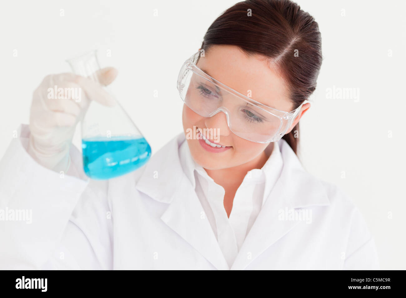 Good looking scientist holding a beaker in a laboratory Stock Photo - Alamy