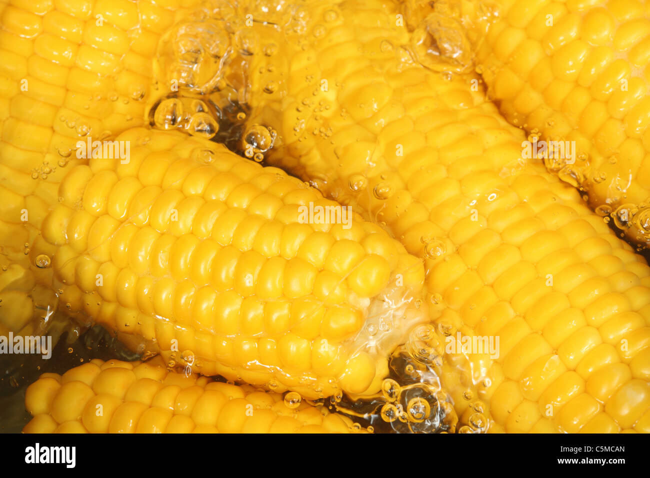 Photograph of cooking corn in pan Stock Photo - Alamy