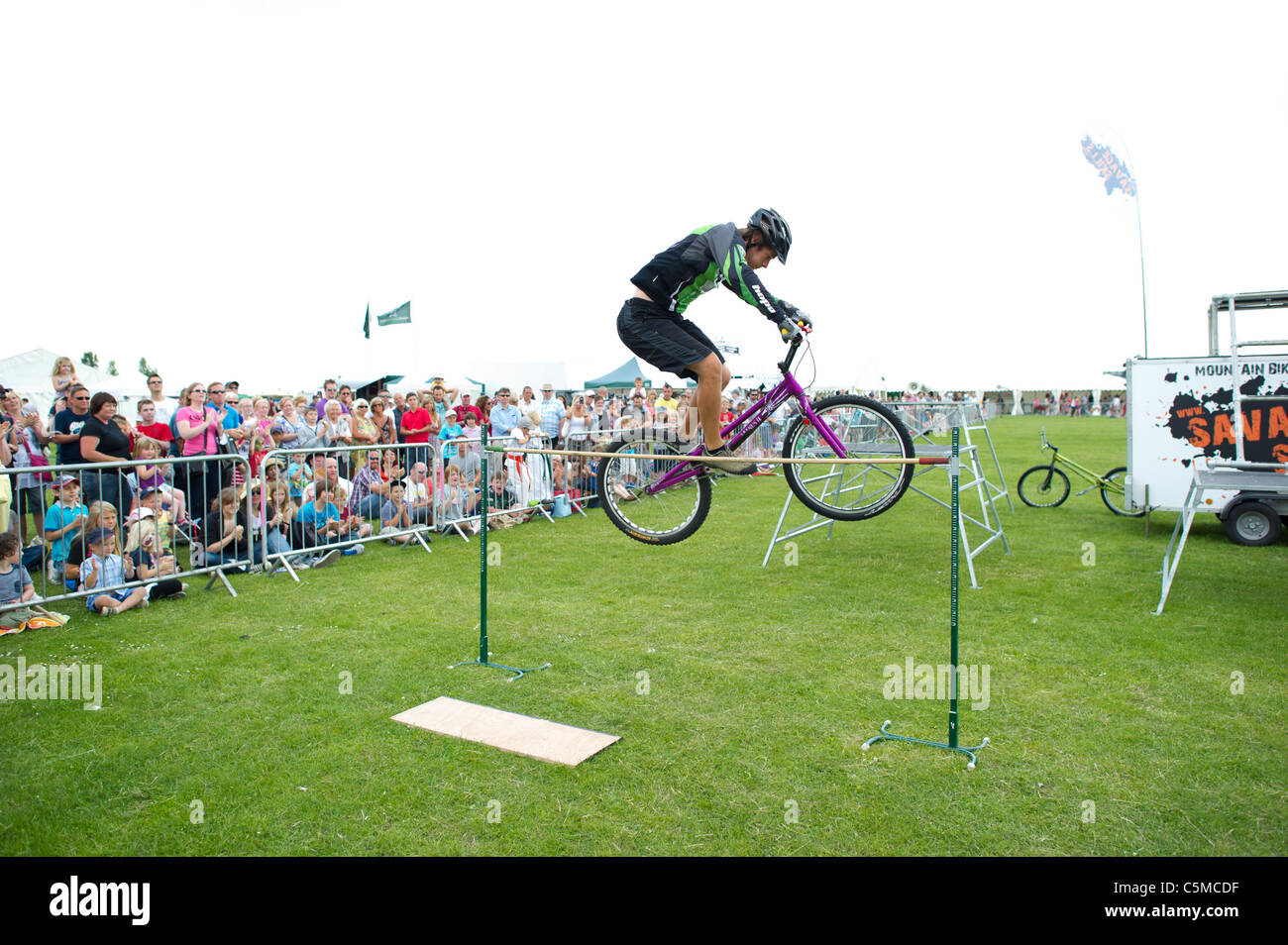 A member of a mountain bike stunt team wows the crowd with high jumps ...