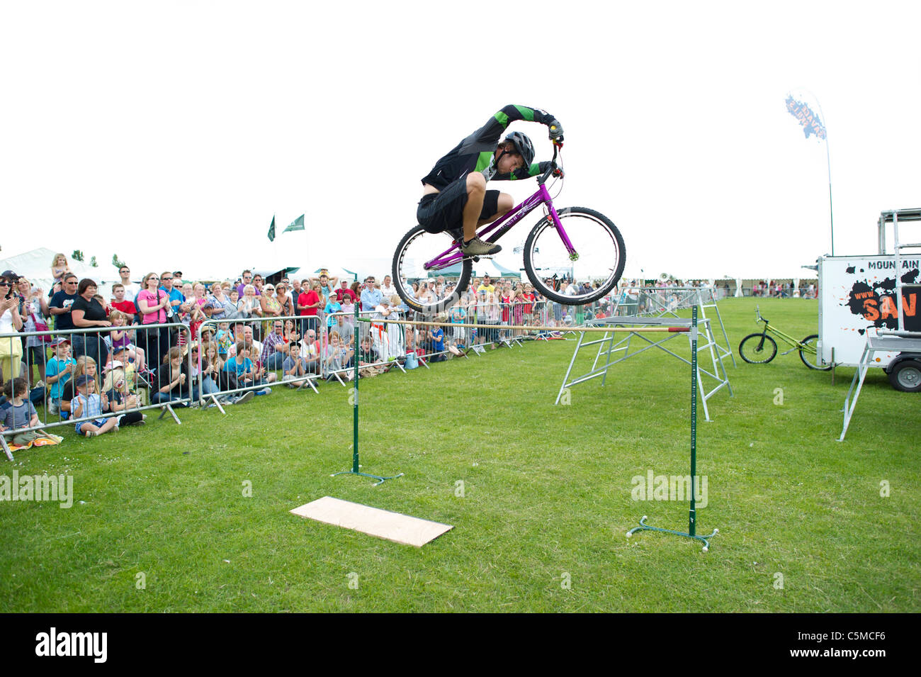 A member of a mountain bike stunt team wows the crowd with high jumps ...