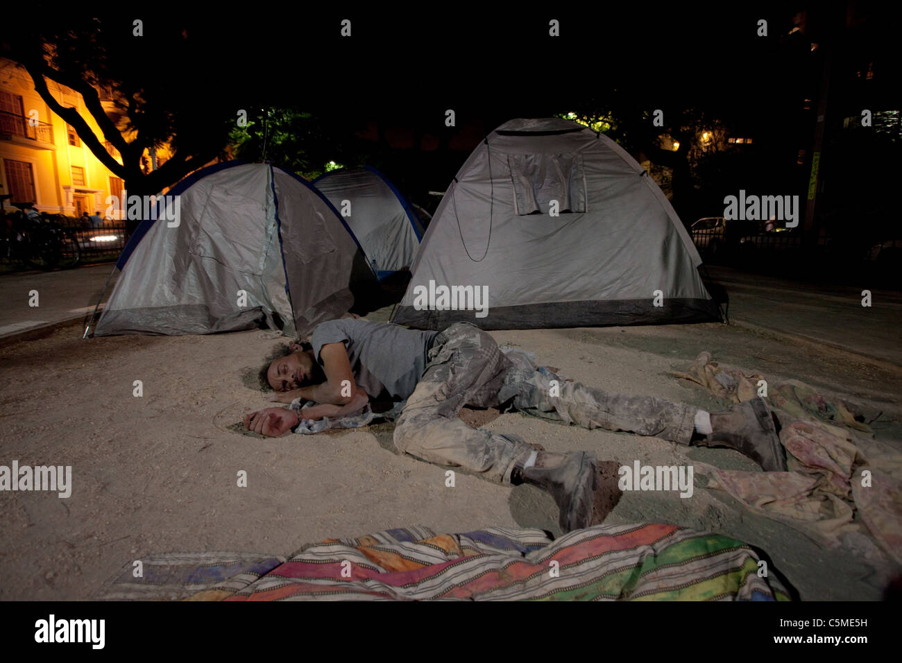 A homeless person sleeps in the Tent City compound in Rothschild avenue ...