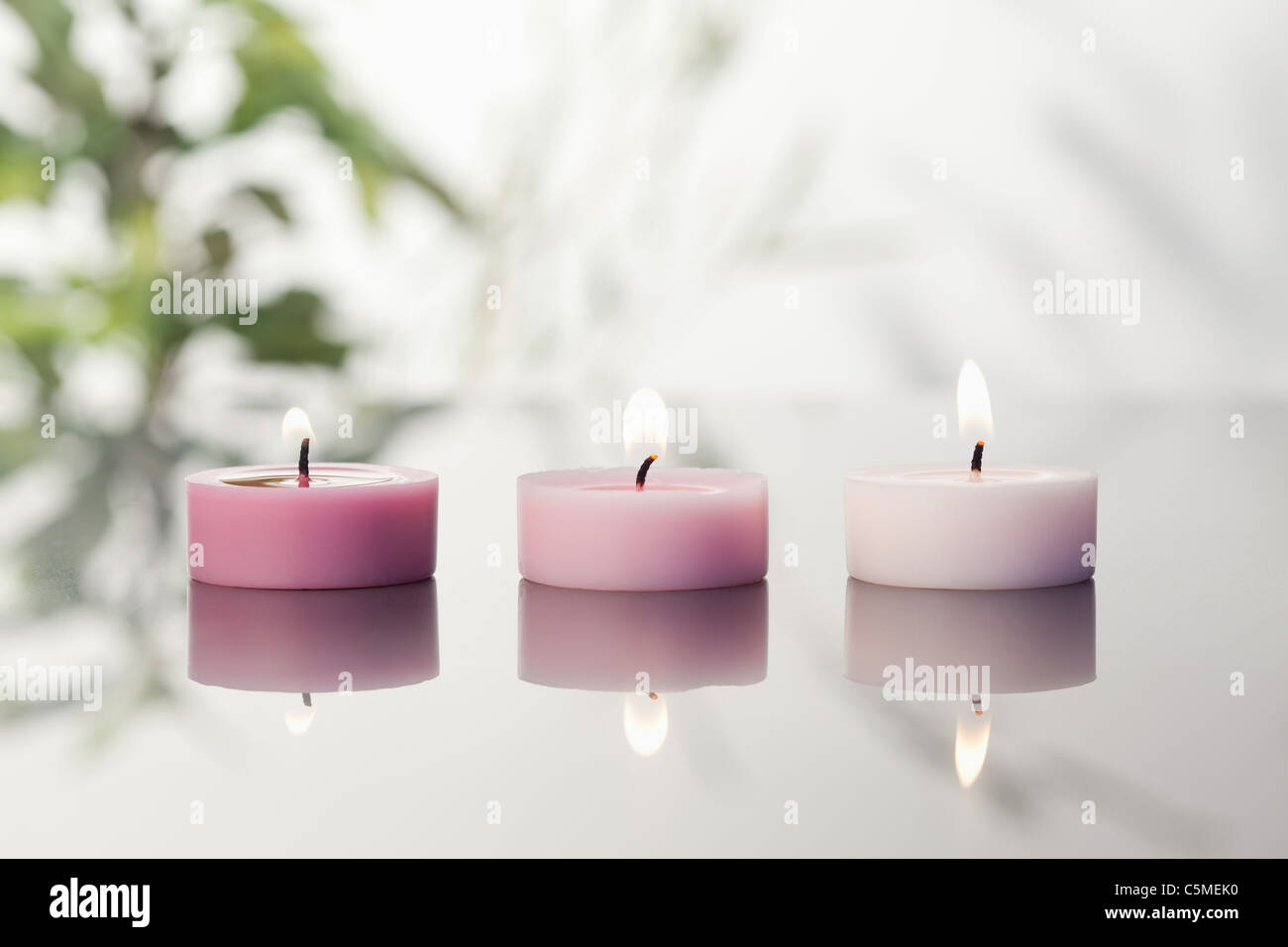 Lighted candles on a mirror Stock Photo - Alamy