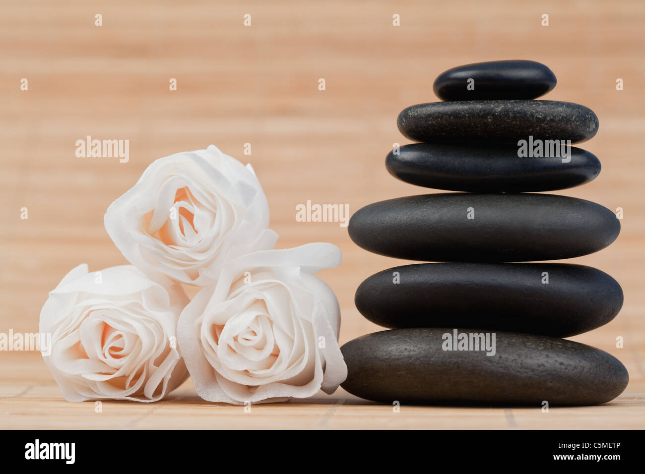 Close up roses and a black pebbles stack Stock Photo - Alamy