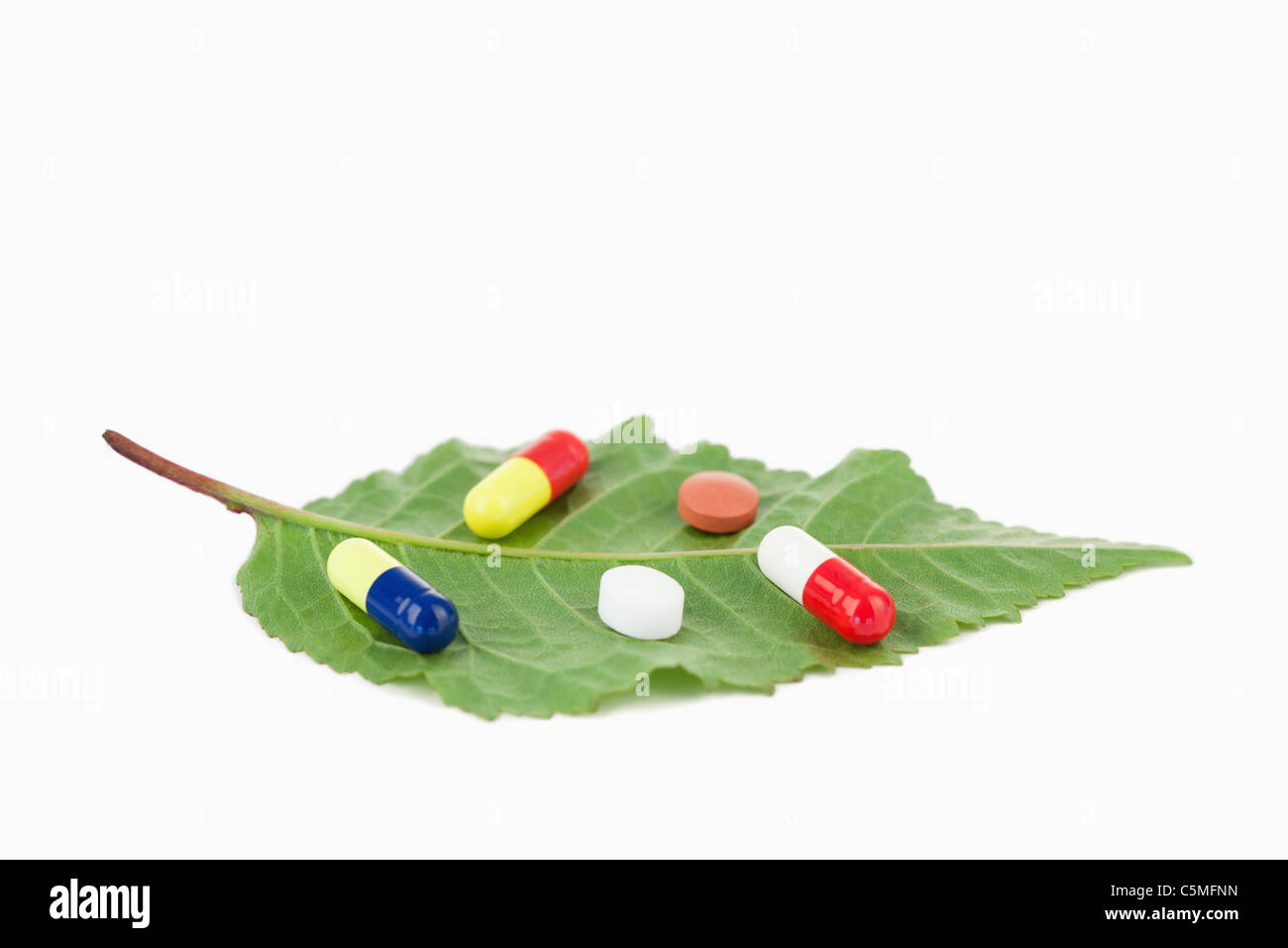 Pills on a leaf Stock Photo - Alamy