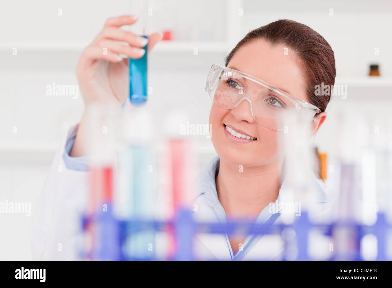 Beautiful scientist lookin at a tube test Stock Photo - Alamy