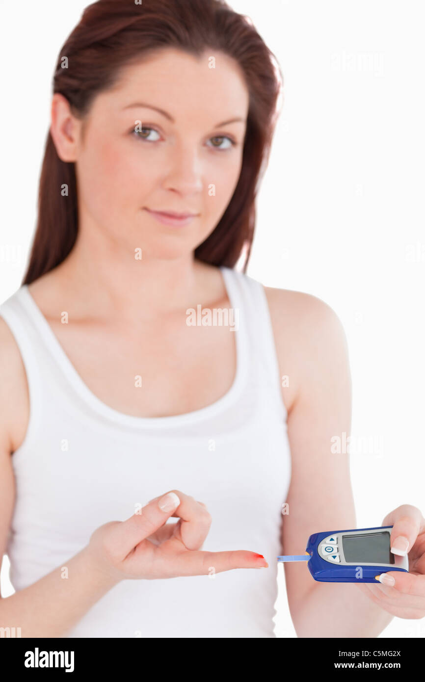 Cute woman testing her blood Stock Photo - Alamy