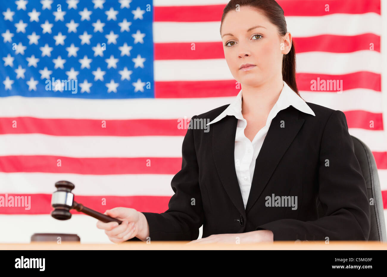 Serious judge knocking a gavel Stock Photo - Alamy