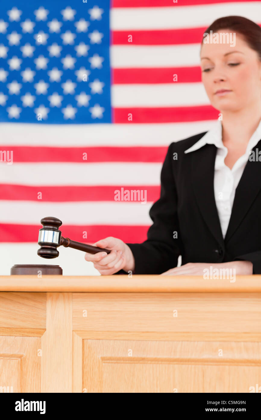 Portrait of a focused judge knocking a gavel Stock Photo - Alamy