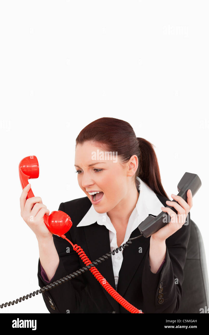 Beautiful secretary driven crazy by the phone calls Stock Photo - Alamy