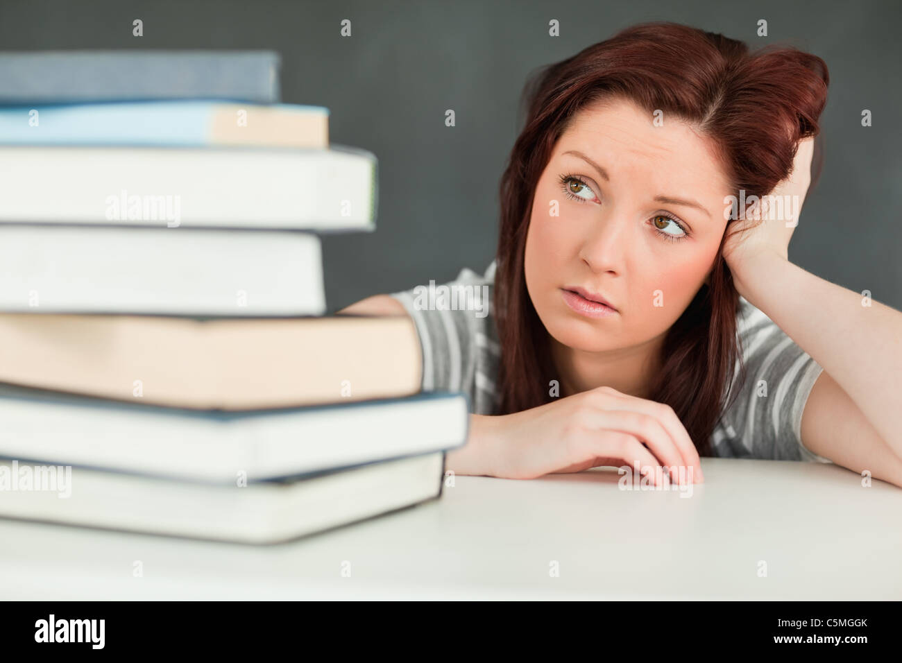 Young student looking at the amount of books she has to read Stock ...