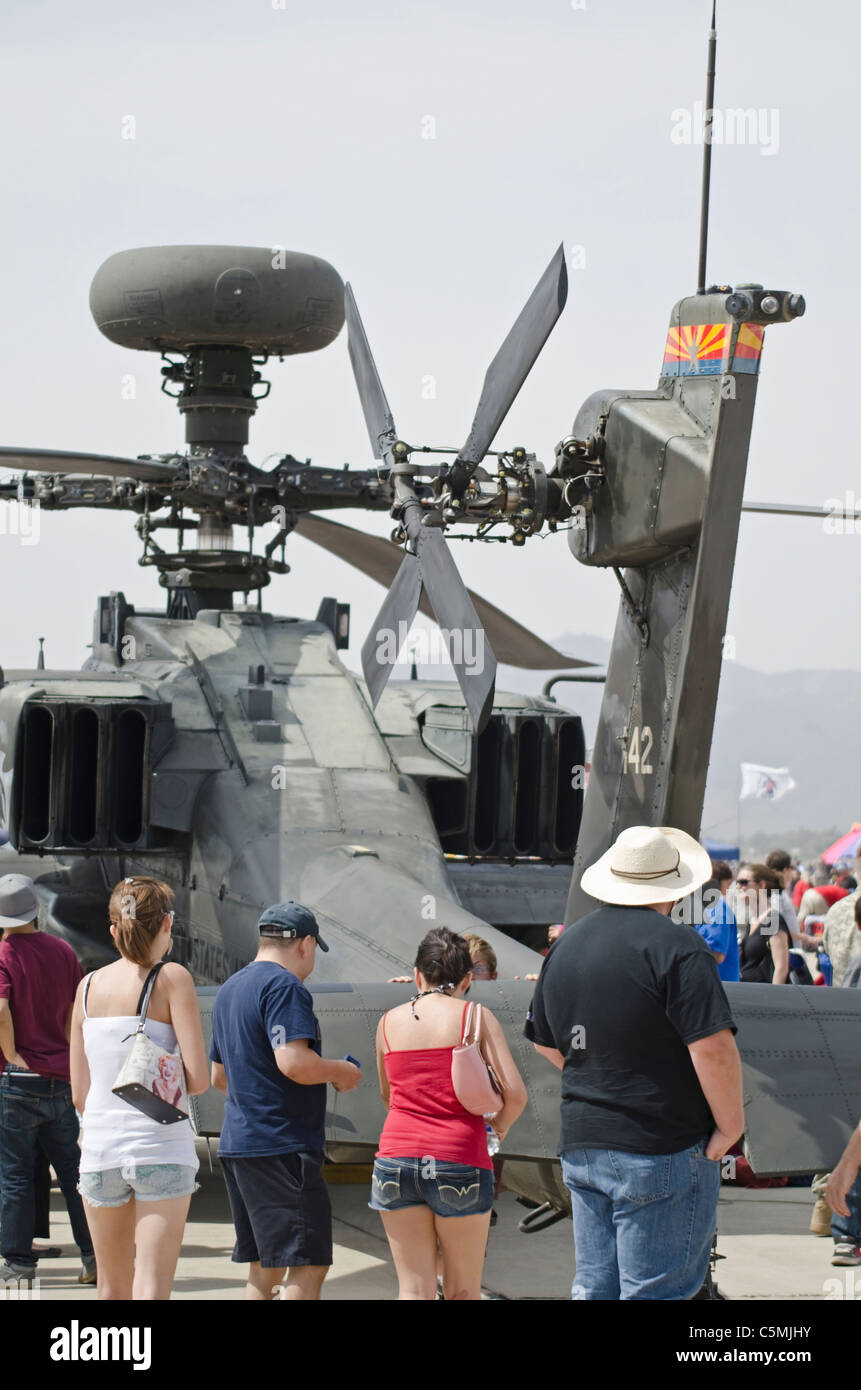 People attending an air show admire a military helicopter at Luke Air ...