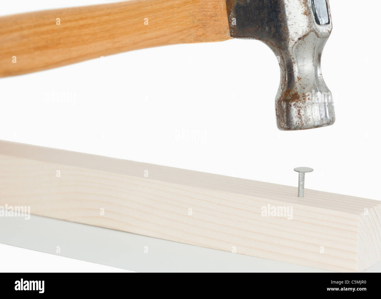 Hammer driving a nail Stock Photo - Alamy