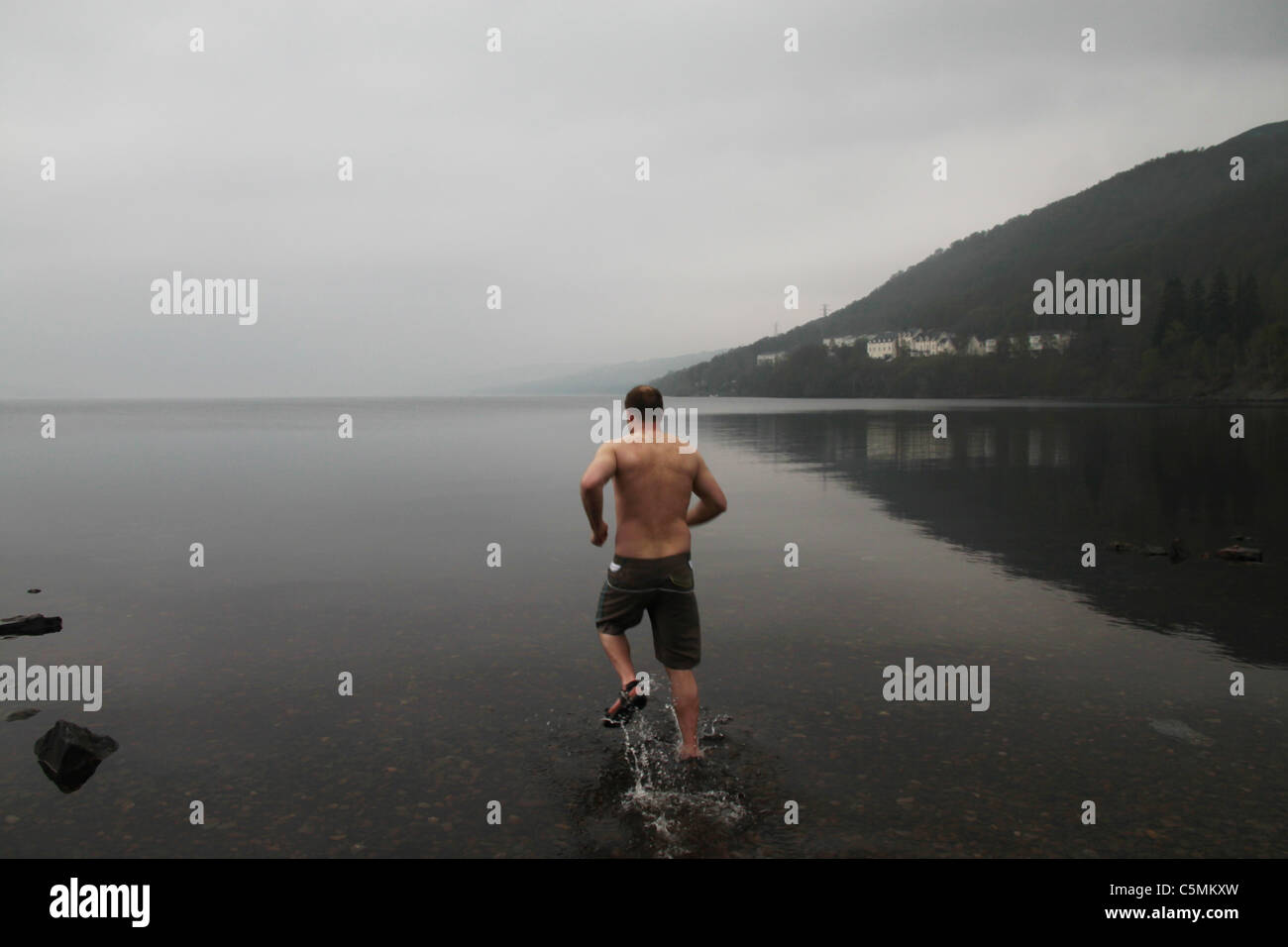 Swimmer running into Loch Rannoch, Kinloch Rannoch, Perthshire Scotland ...