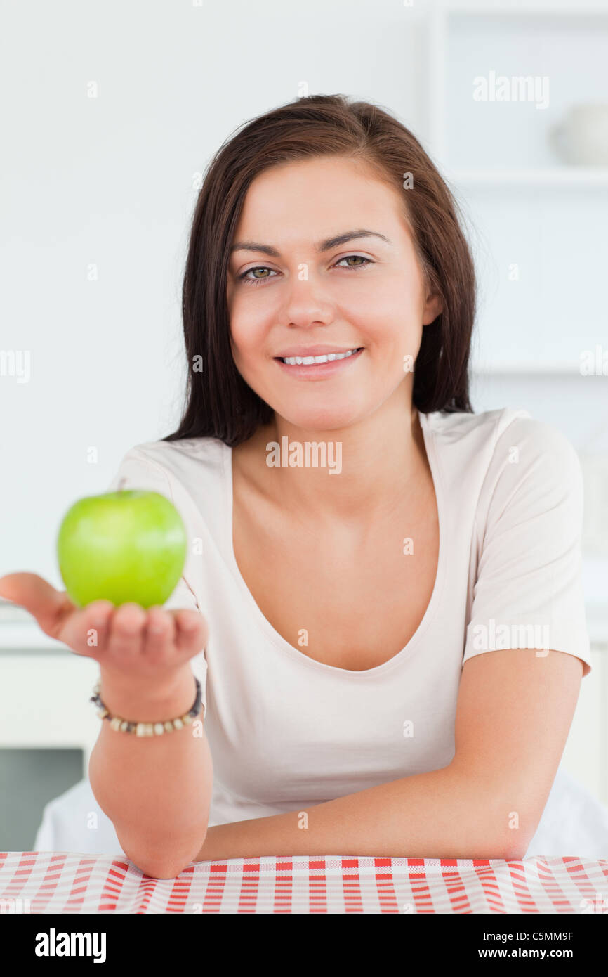 Charming brunette showing an apple Stock Photo - Alamy