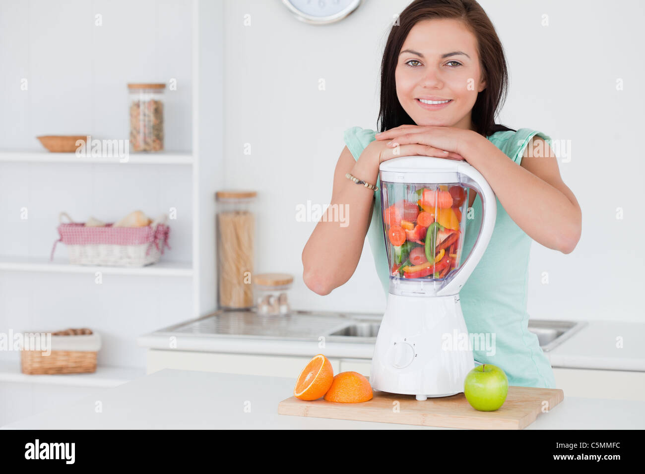 Brunette posing with a blender Stock Photo - Alamy