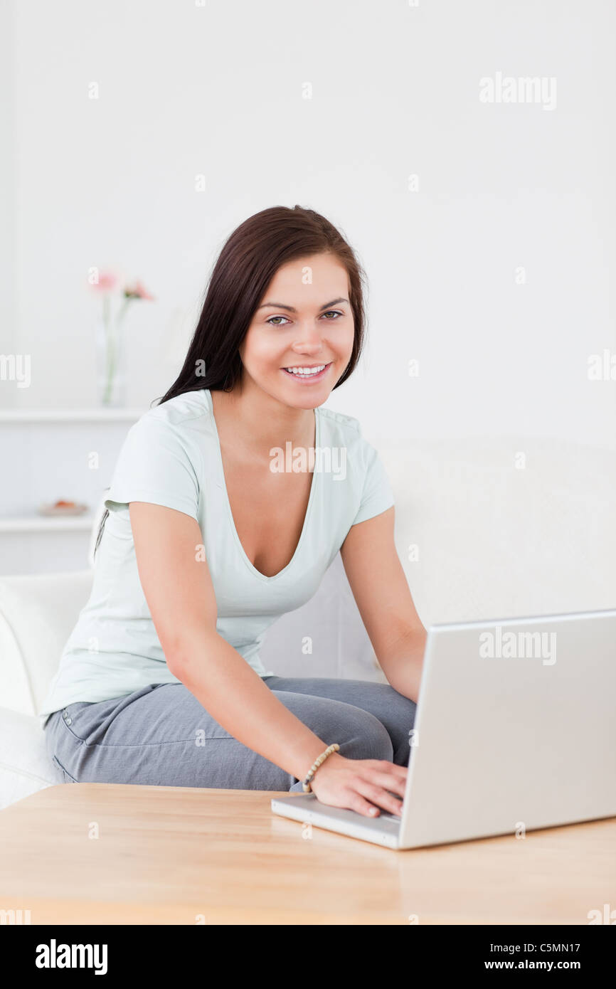 Portrait of a young woman typing on her laptop Stock Photo - Alamy