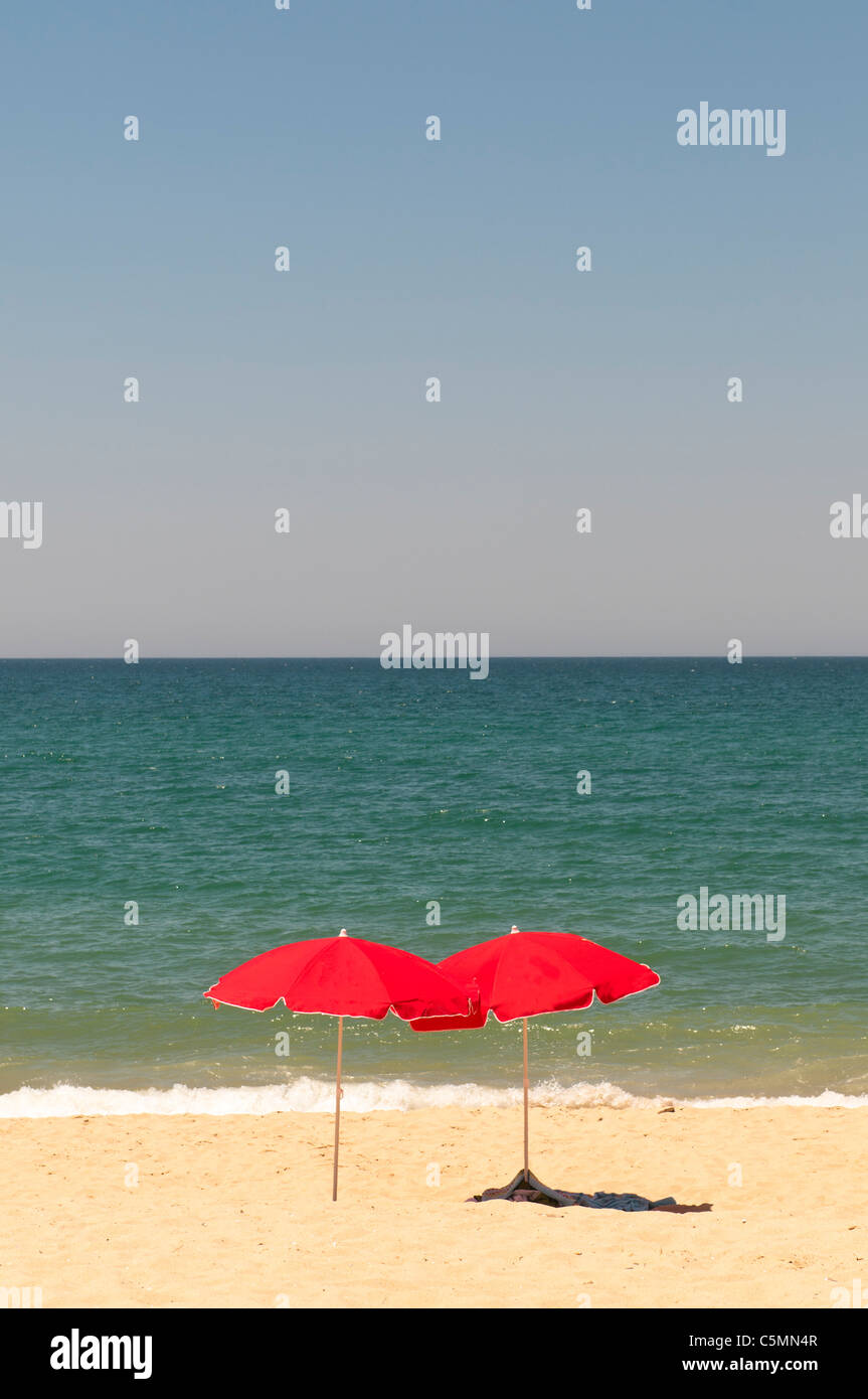 Parasol on sandy beach in Algarve, Portugal Stock Photo - Alamy