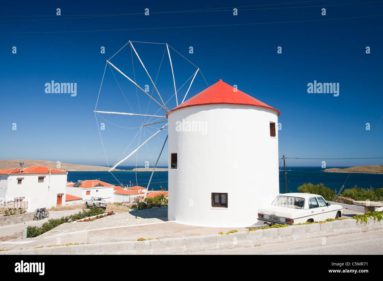 A traditional cloth sailed windmill converted into a house in Sigri, on ...