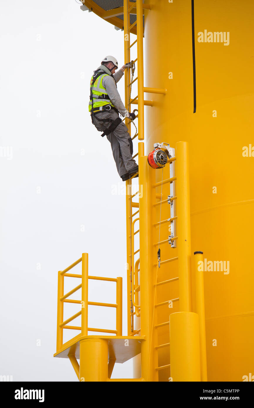 Offshore workers working on a wind turbine at the Walney Offshore ...