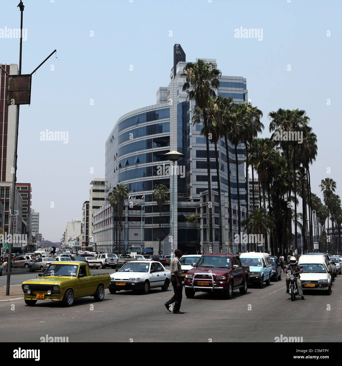 A man crosses a busy street in downtown Harare, Zimbabwe Stock Photo ...