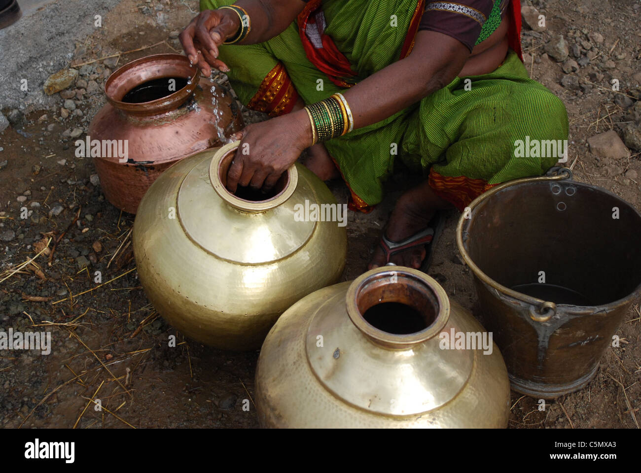 woman washing brass pot Stock Photo - Alamy