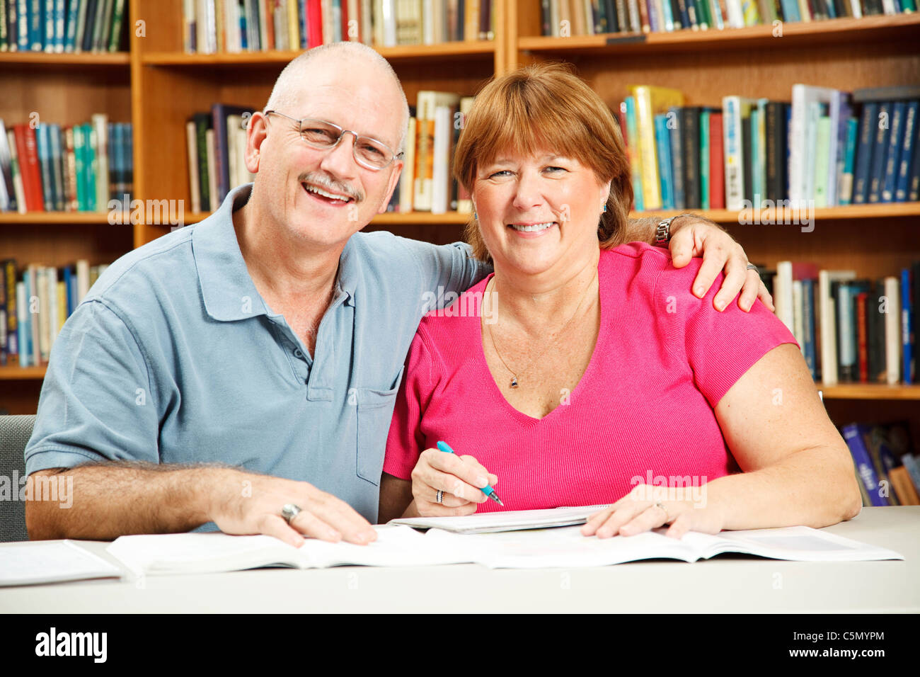 Middle aged adult education students studying in the library Stock ...