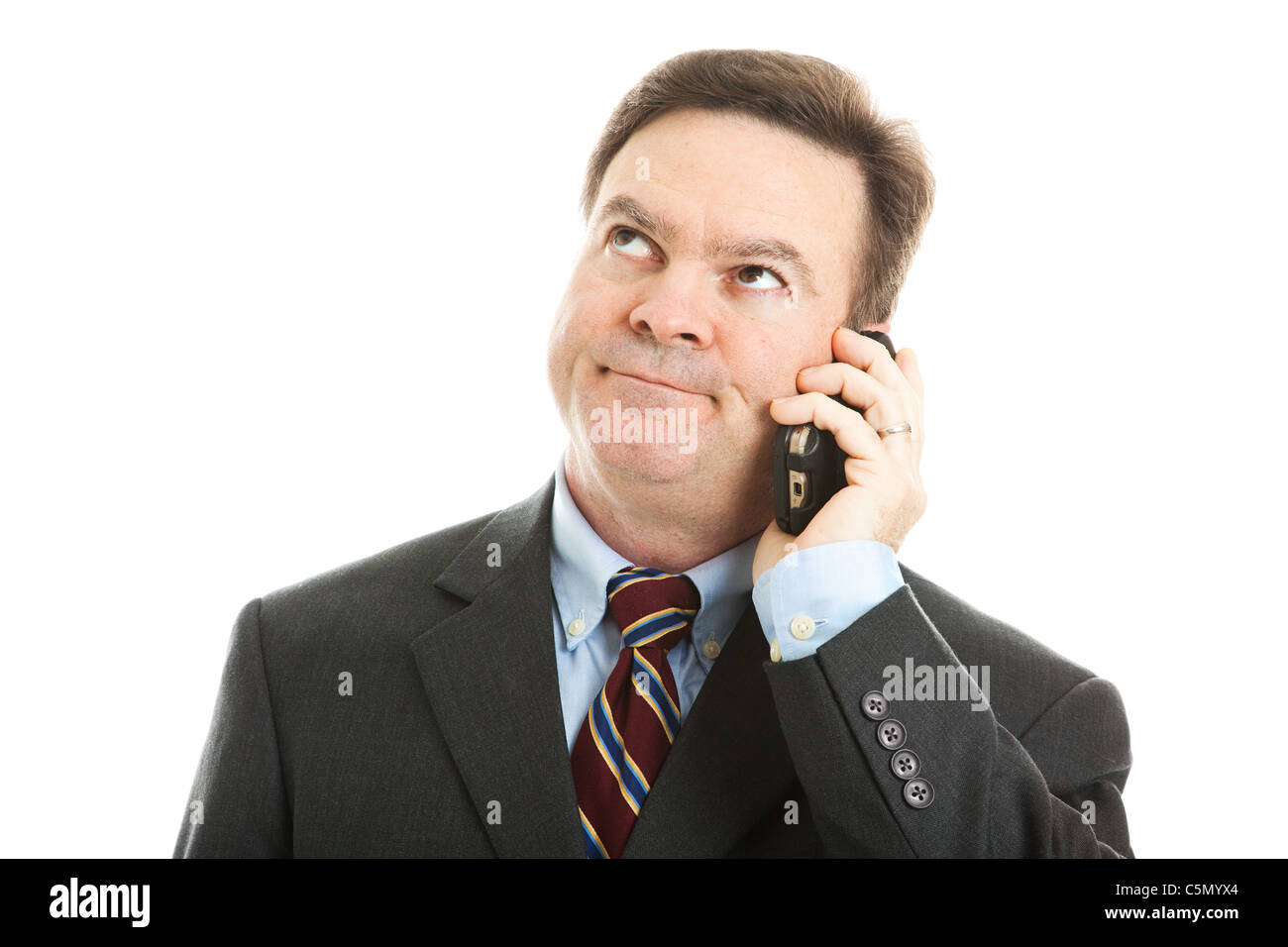 Businessman rolling his eyes as he listens to a boring phone call or ...