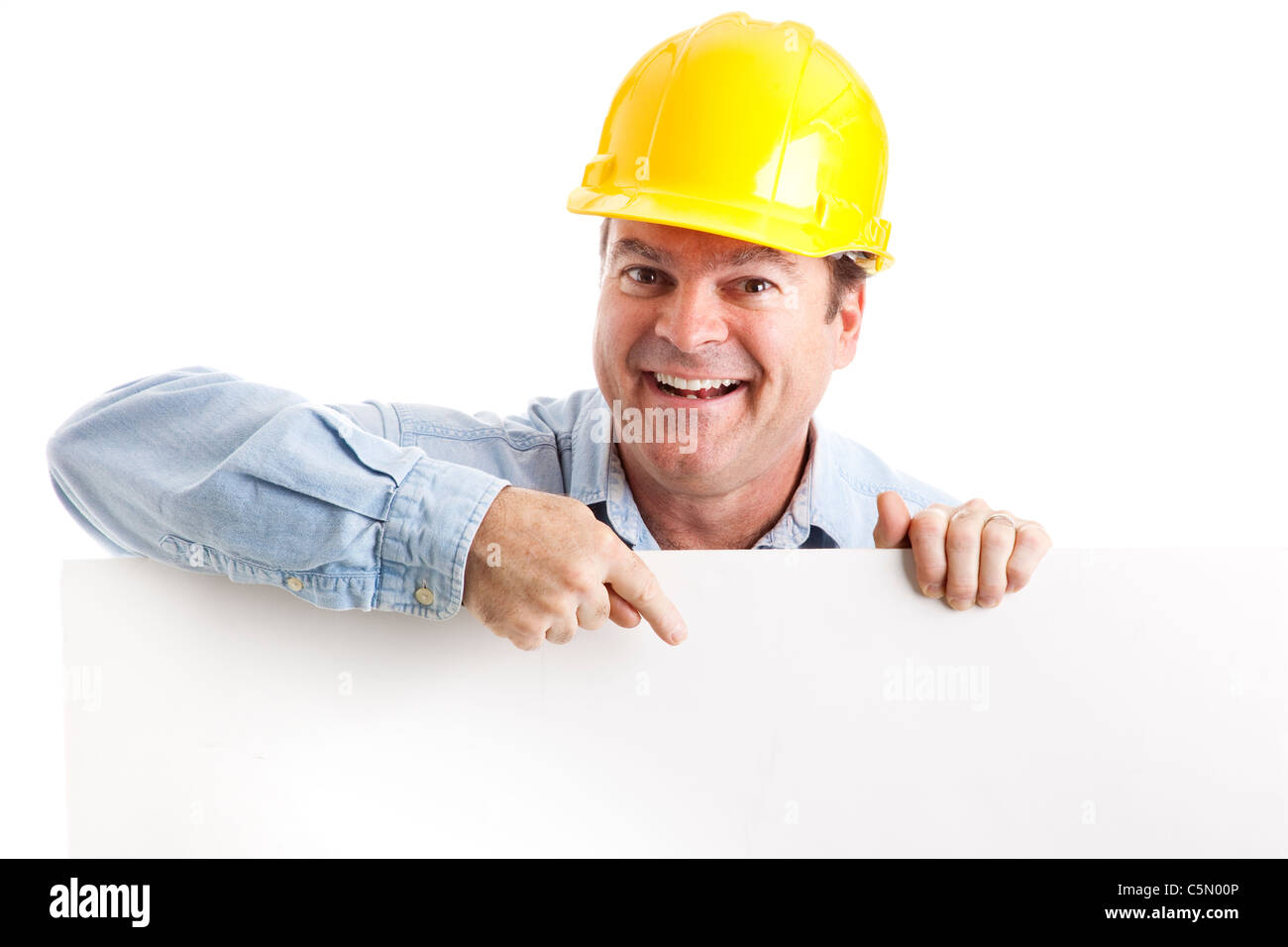 Construction worker leaning over and pointing to blank white space ...