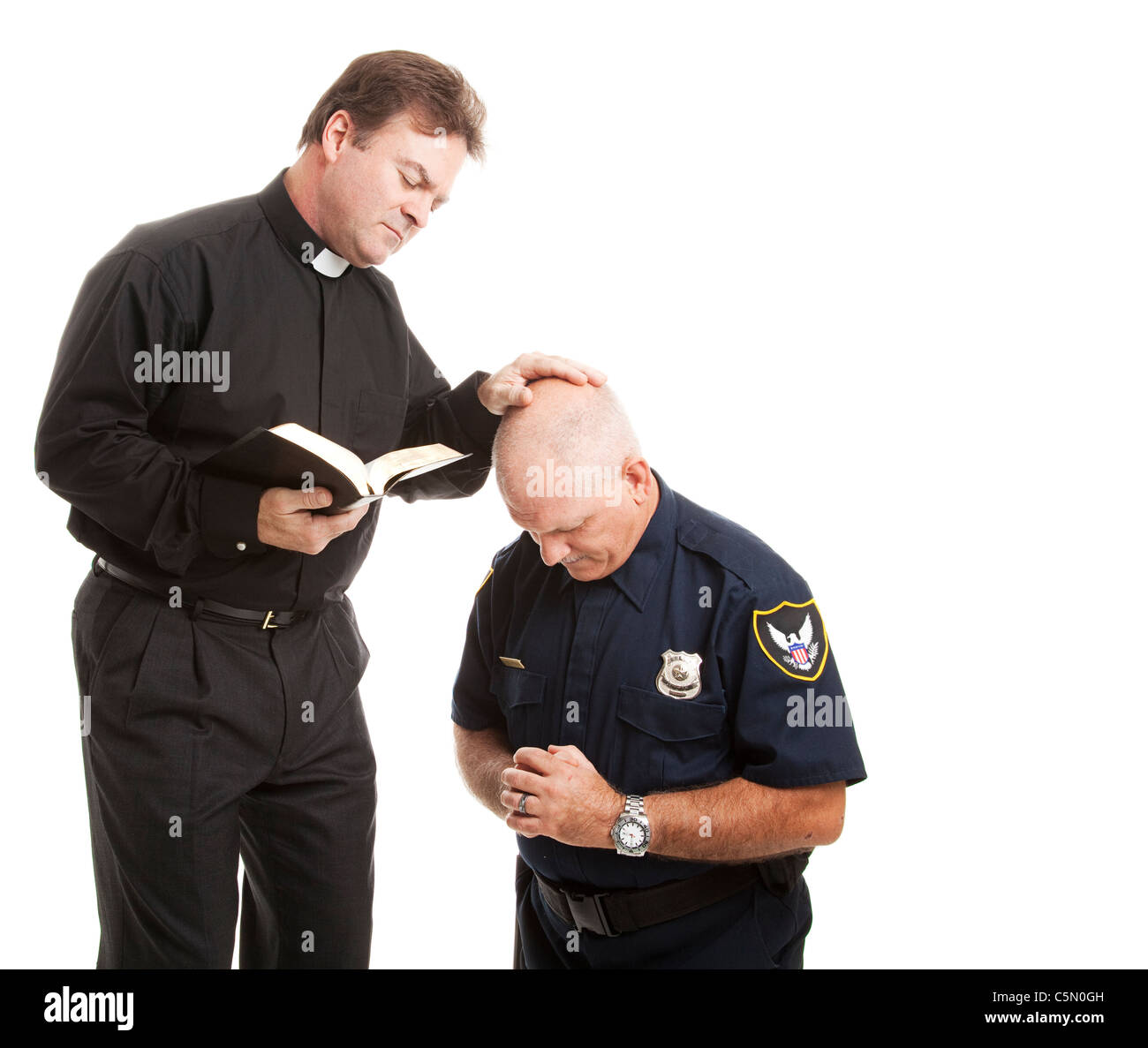 Police officer gets a blessing from his priest. Isolated on white with ...