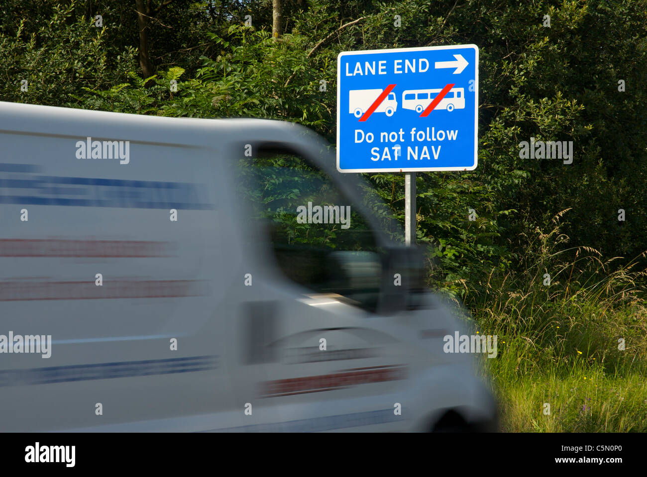 Van passing road sign warning drivers of lorries and buses to ignore ...