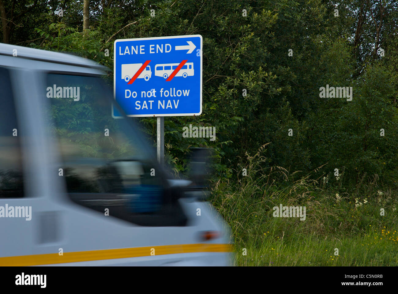 Van passing road sign warning drivers of lorries and buses to ignore ...