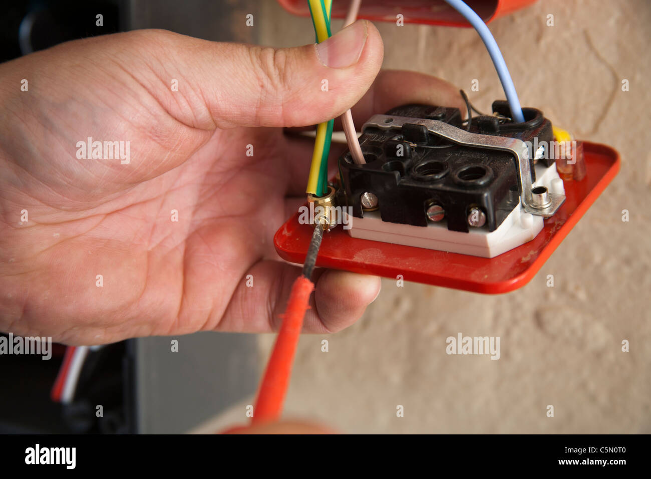 Qualified Electrician installing a Wiring a red fused keyswitch Stock ...