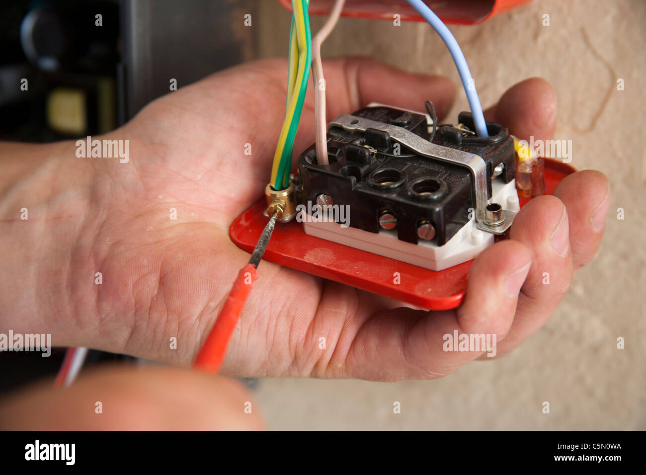 Qualified Electrician installing a Wiring a red fused keyswitch Stock ...