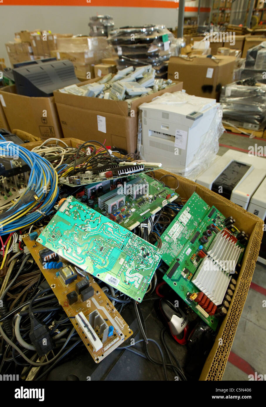 Piles of outdated electronics and high tech devices, are gathered and ...