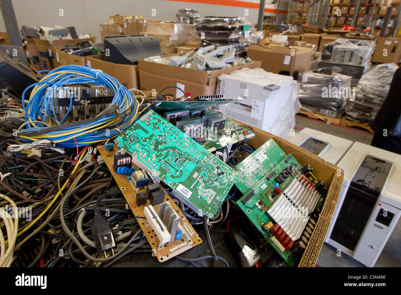 Piles of outdated electronics and high tech devices, are gathered and ...