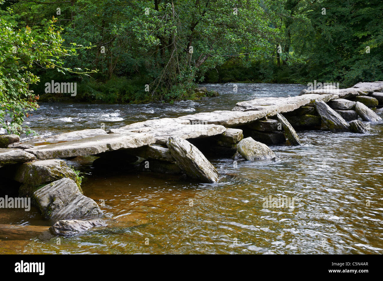 Tarr Steps a medieval clapper bridge across the River Barle near ...
