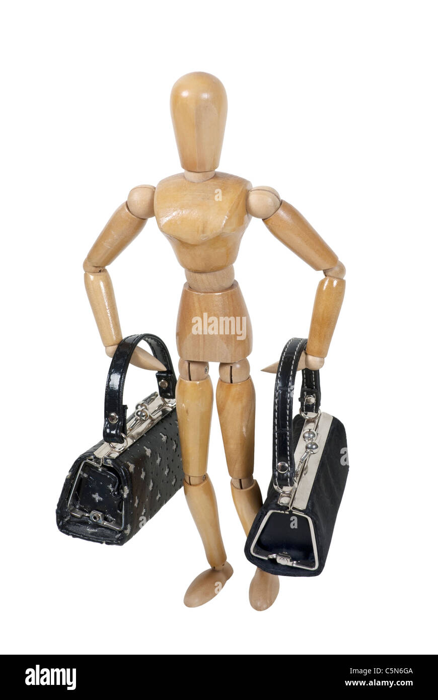 Wooden model carrying black bags of luggage for traveling - path ...