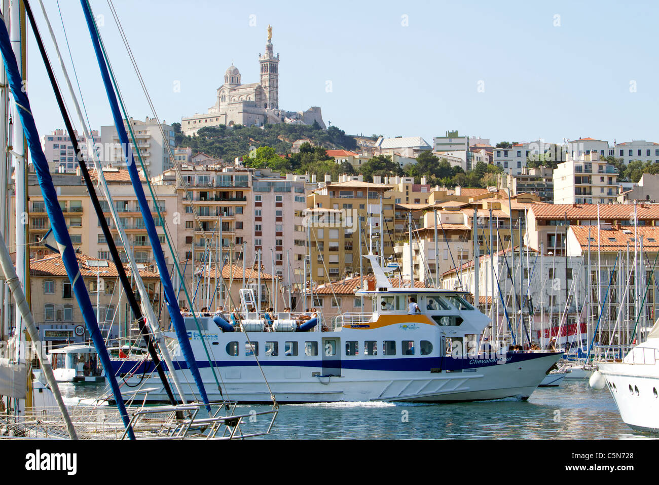 Marseille France marina with sailboats, cruise boats with Basilica ...