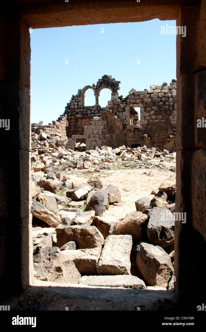 Looking though a doorway at the ancient basalt stone city and ...