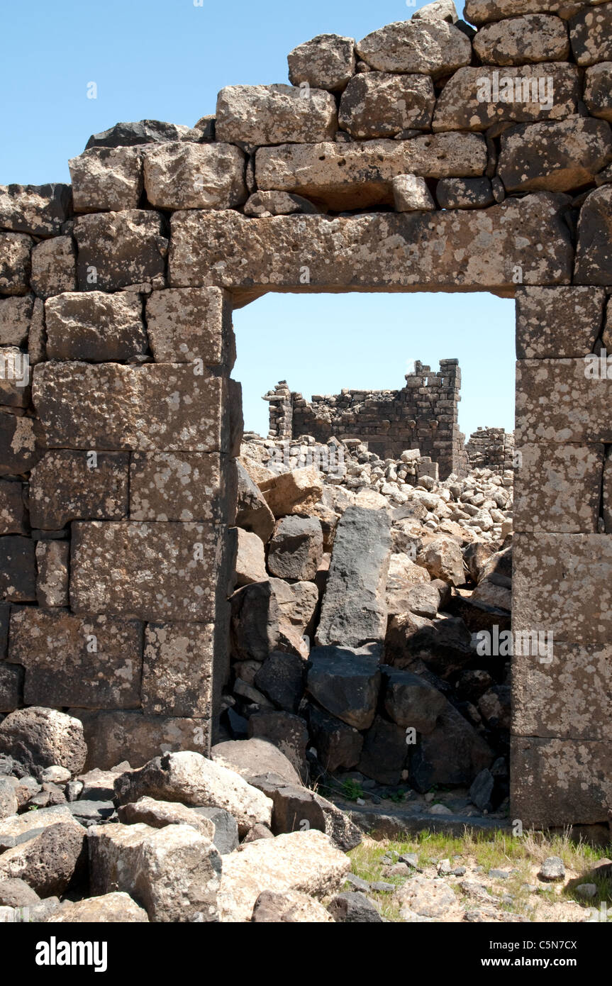 The basalt stone ruins of a home in the ancient city and archaeological ...