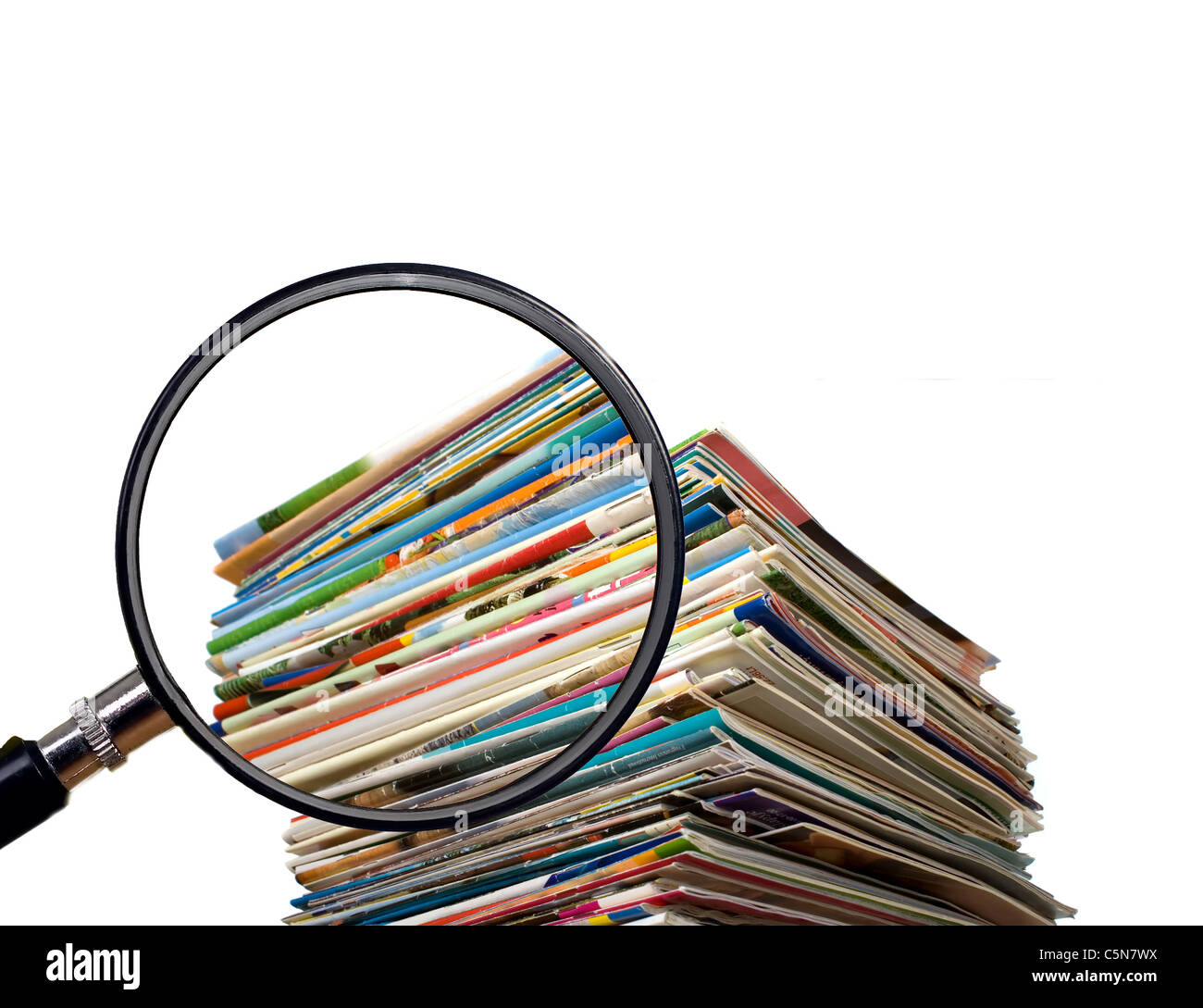 Magnifying glass magnifies many documents and catalogs Stock Photo - Alamy