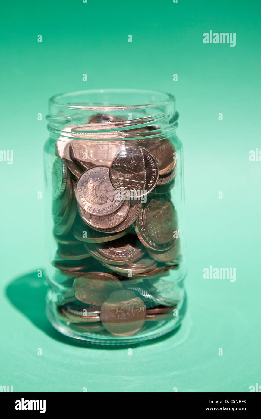 Glass jar with coins Stock Photo - Alamy