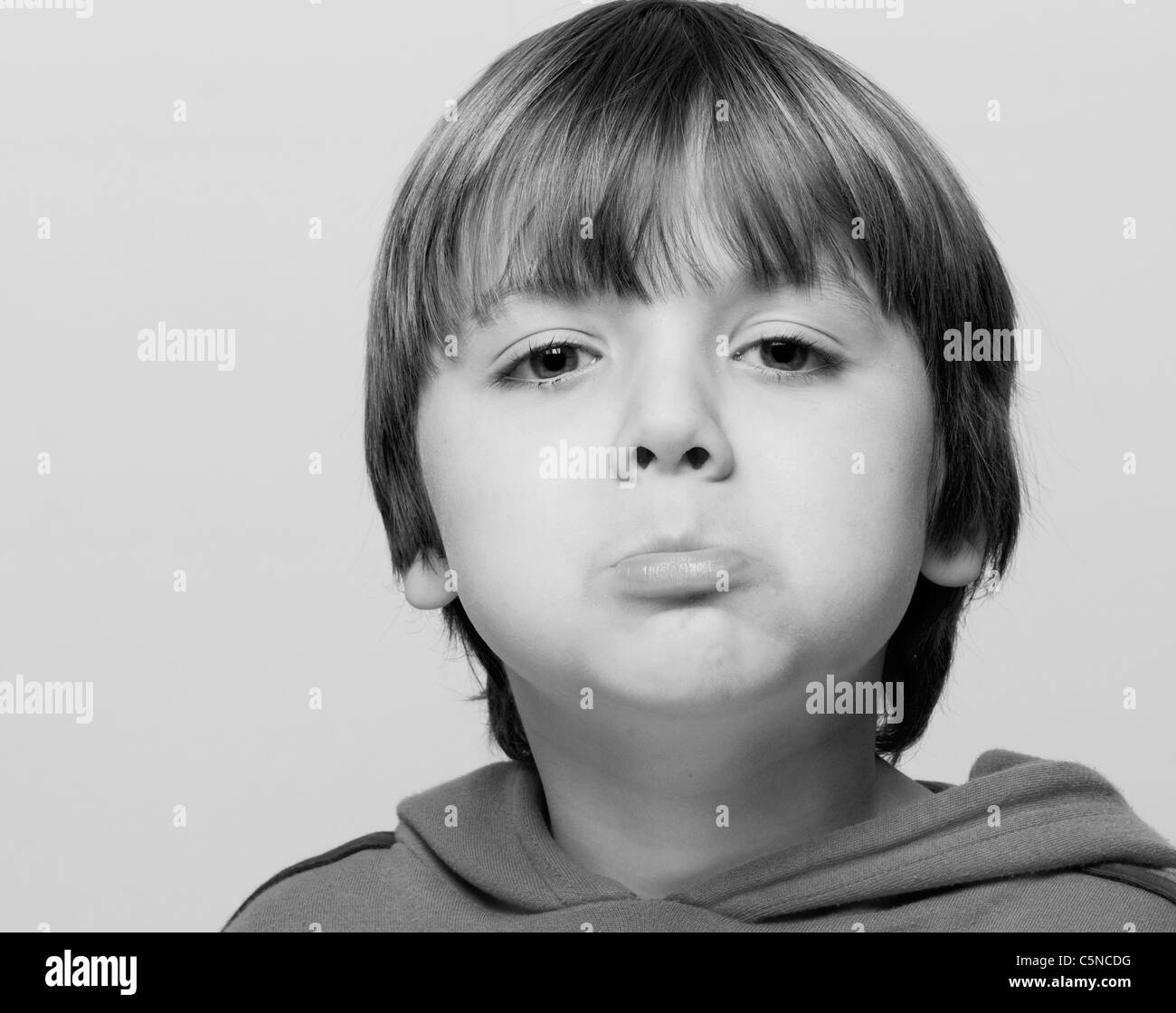 Portrait of a young boy, sulking Stock Photo - Alamy