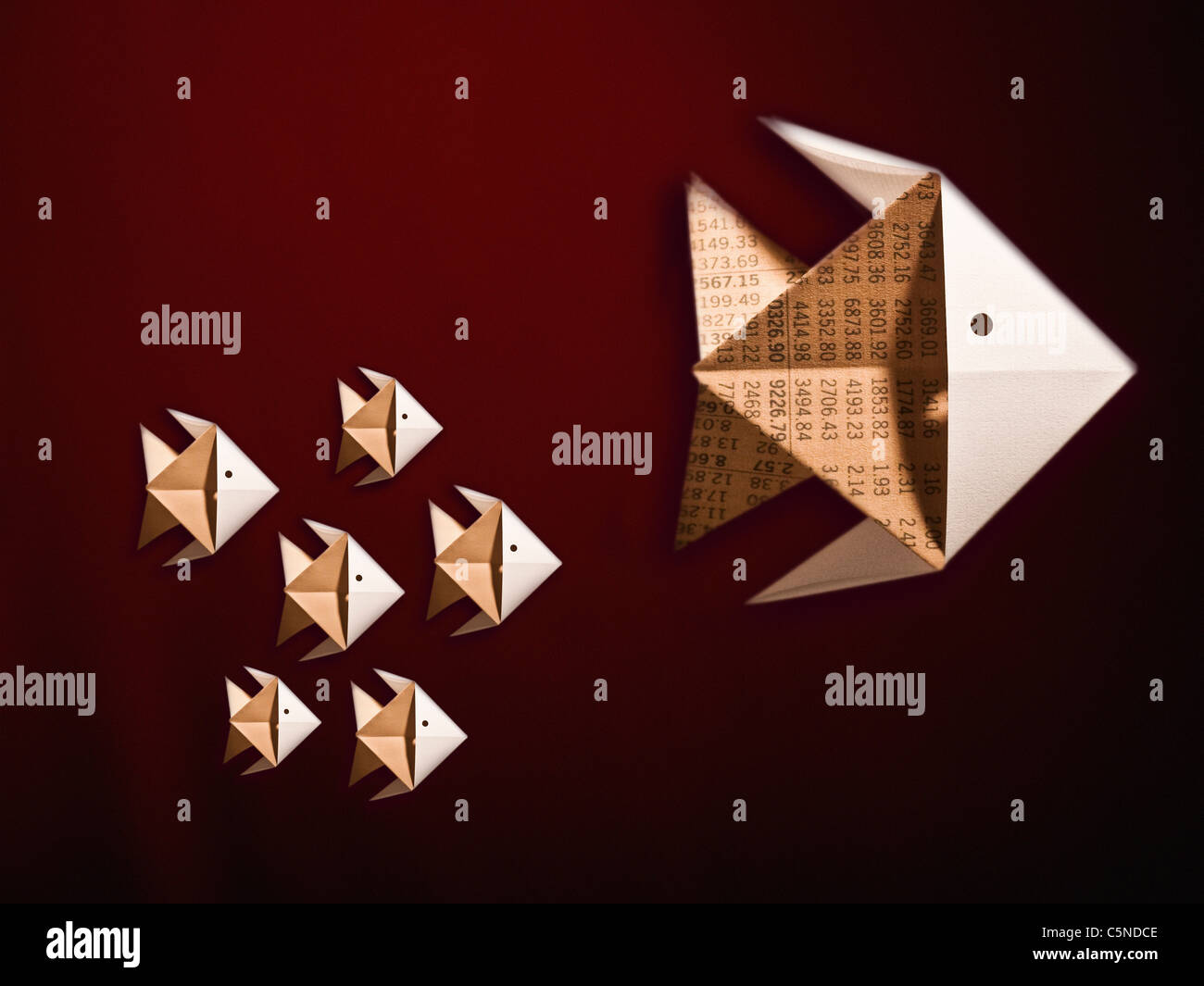 Origami fish made out of financial paper Stock Photo - Alamy